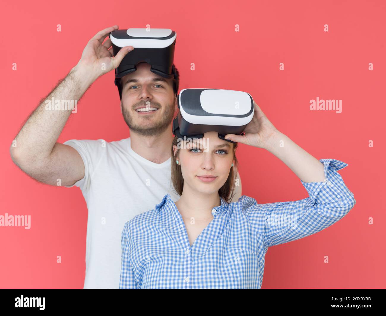 happy young couple getting experience using VR-headset glasses of ...