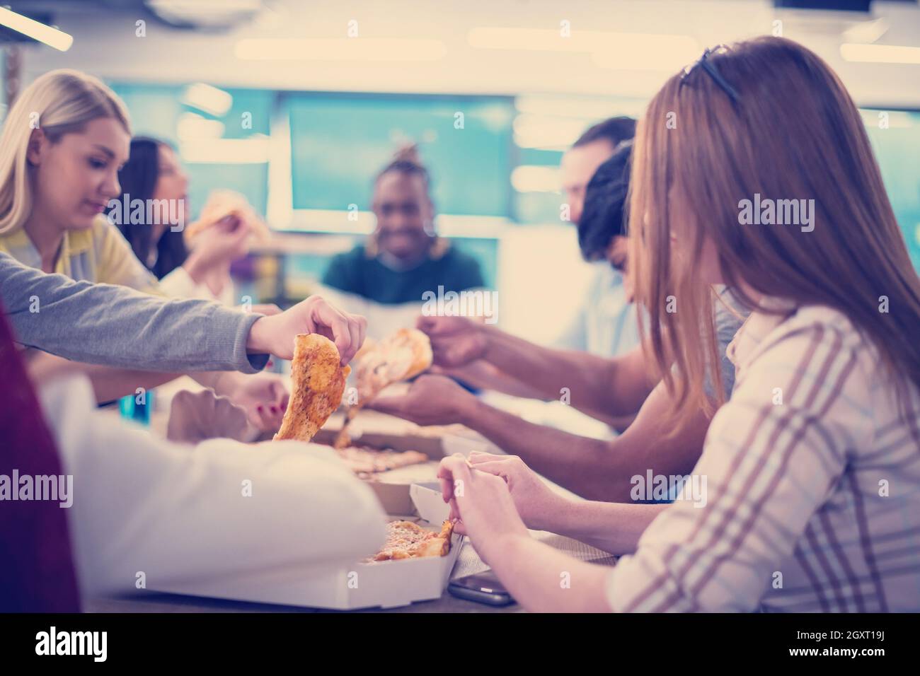 Friendly diverse multiethnic business team eating sharing pizza ...