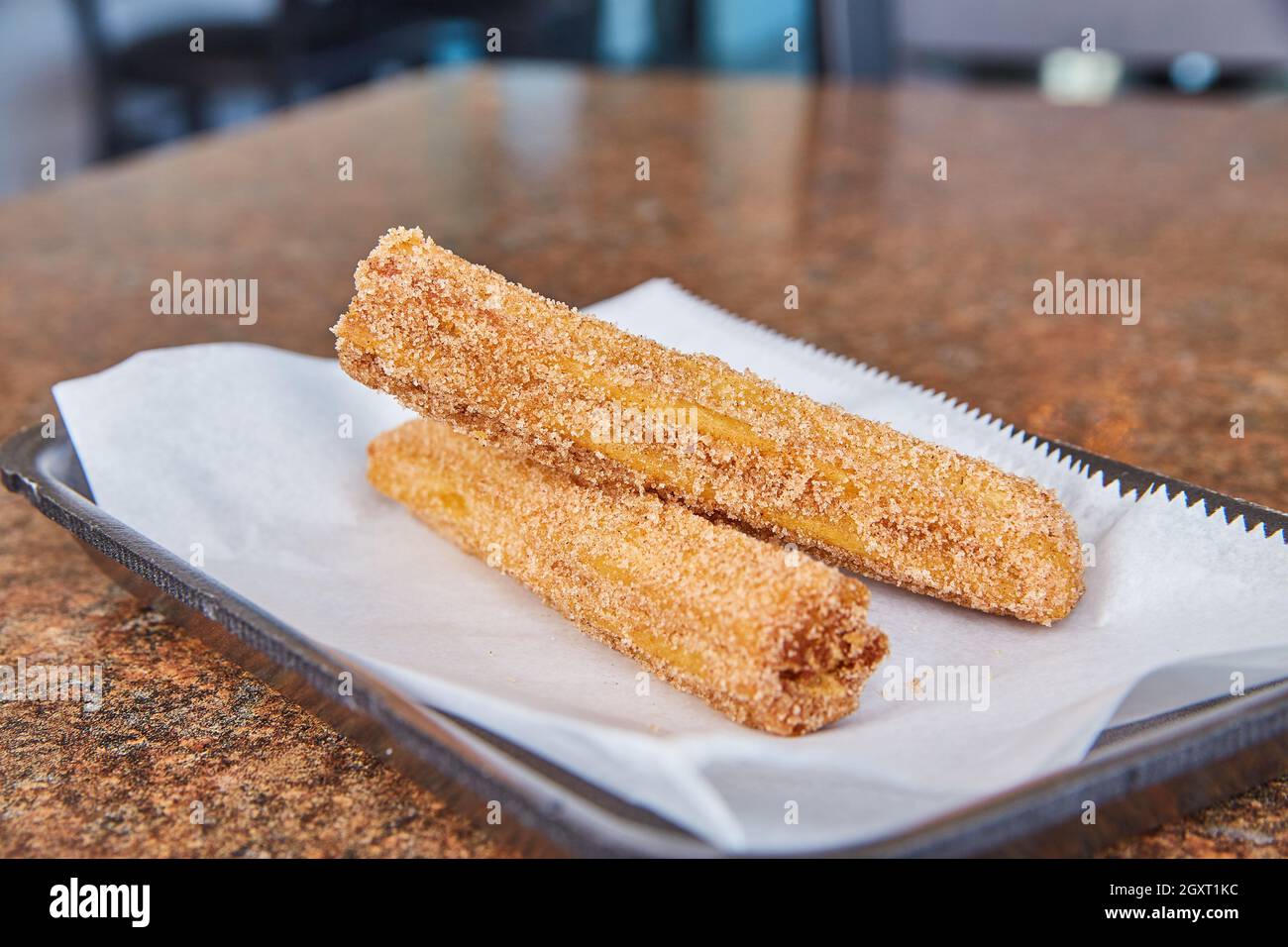 Single Mexican churro covered in sugar Stock Photo - Alamy
