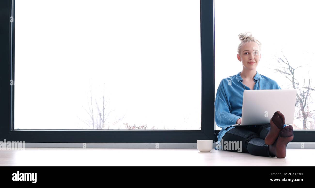 beautiful young women using laptop computer on the floor of her luxury ...