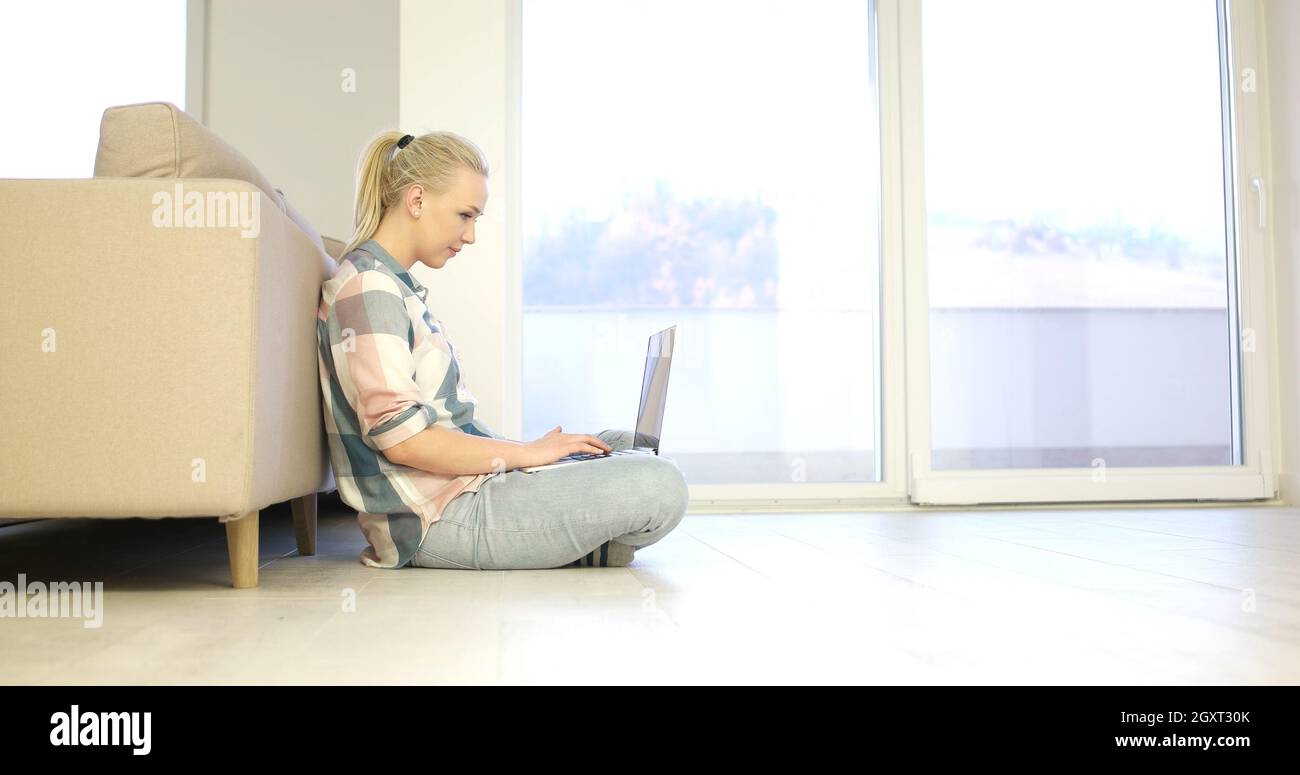 beautiful young women using laptop computer on the floor of her luxury ...