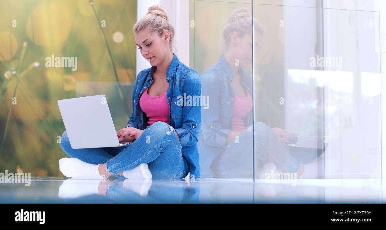 beautiful young women using laptop computer on the floor of her luxury ...