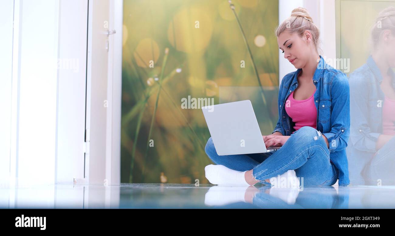 beautiful young women using laptop computer on the floor of her luxury ...