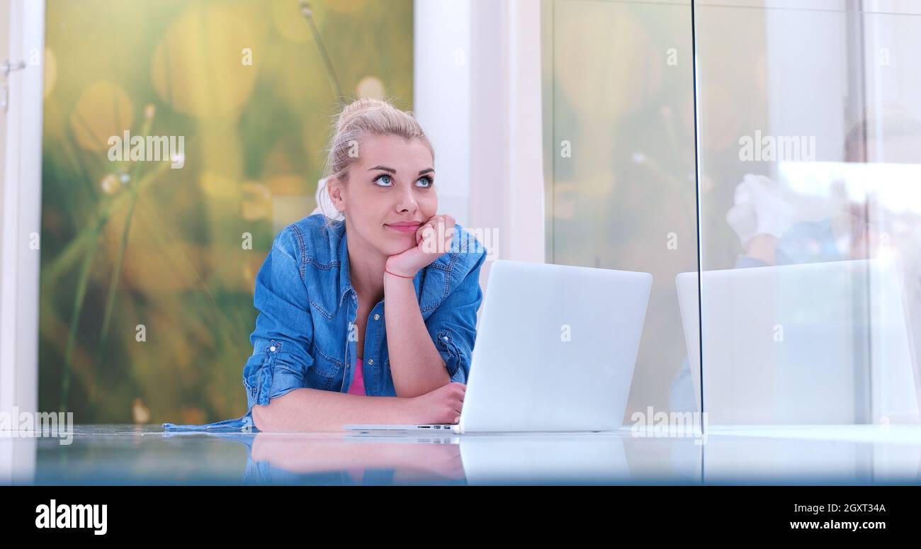 beautiful young women using laptop computer on the floor of her luxury ...