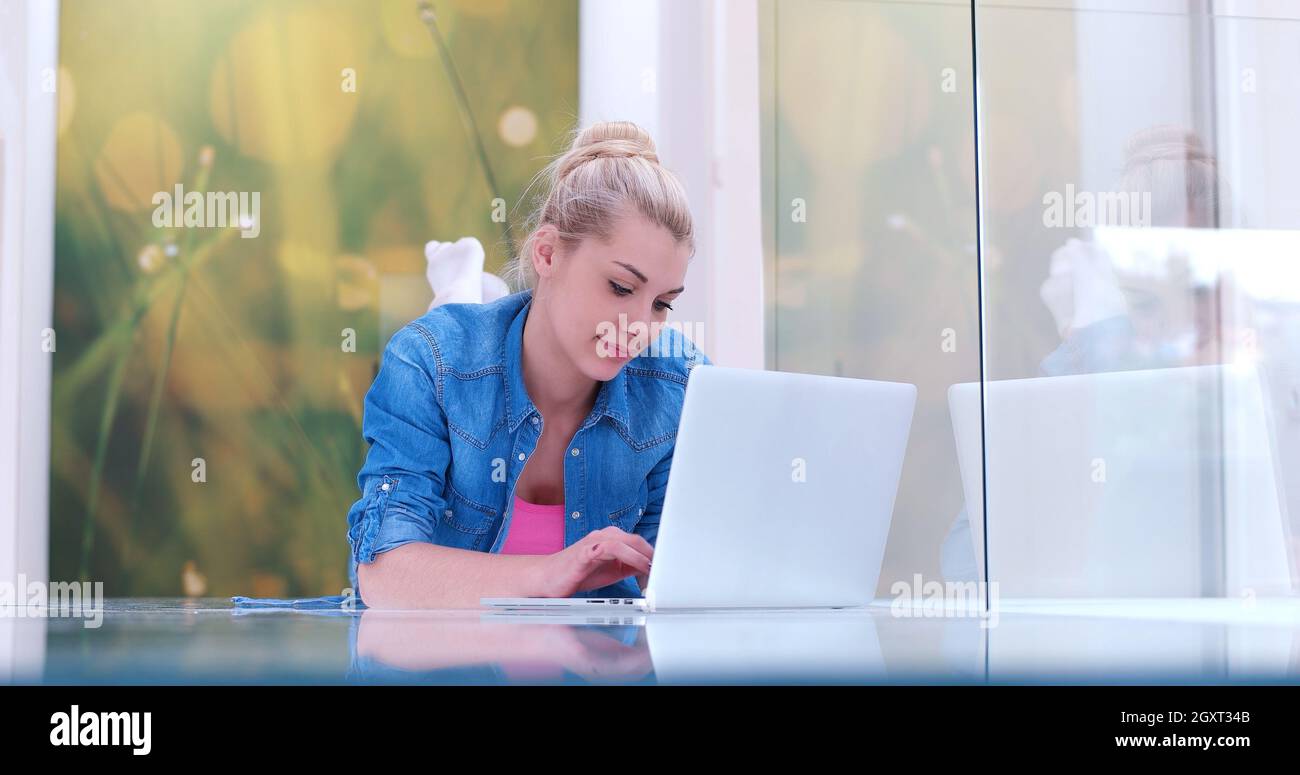 beautiful young women using laptop computer on the floor of her luxury ...
