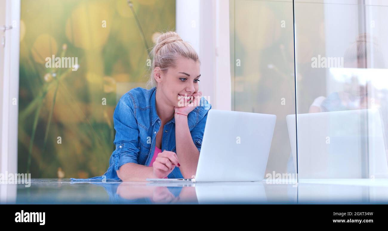 beautiful young women using laptop computer on the floor of her luxury ...
