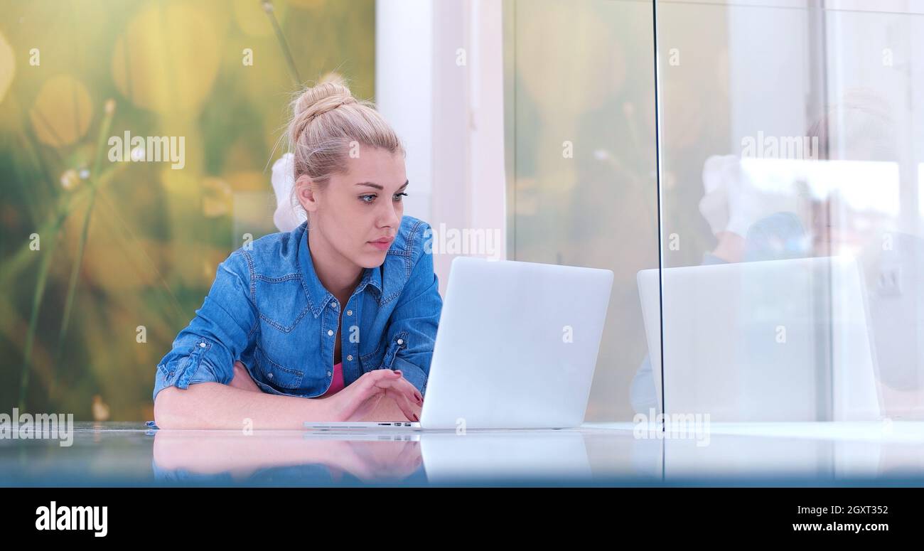 beautiful young women using laptop computer on the floor of her luxury ...