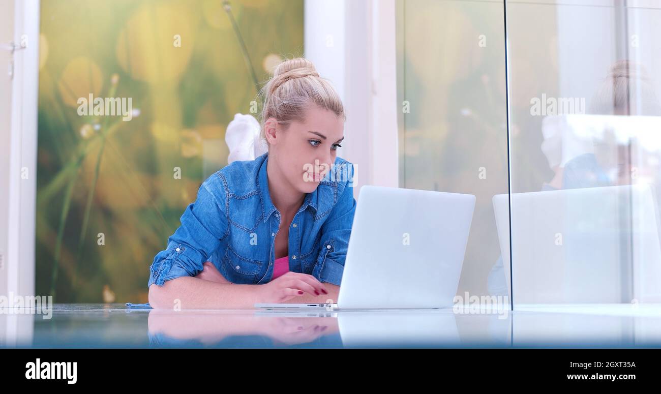 beautiful young women using laptop computer on the floor of her luxury ...