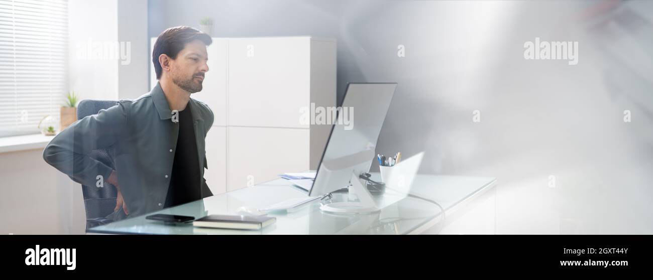 Bad Posture. Sitting With Back Pain At Office Computer Stock Photo - Alamy