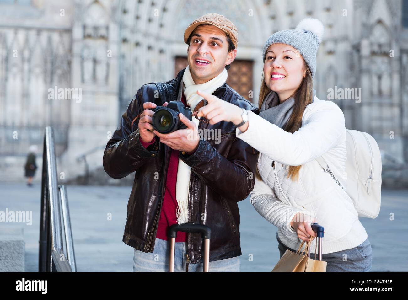 Tourists standing with camera Stock Photo - Alamy
