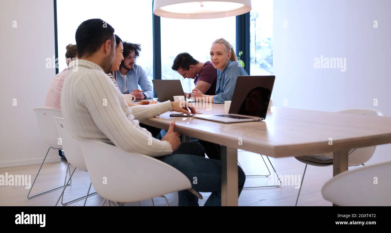 Group of a young business people discussing business plan at modern ...