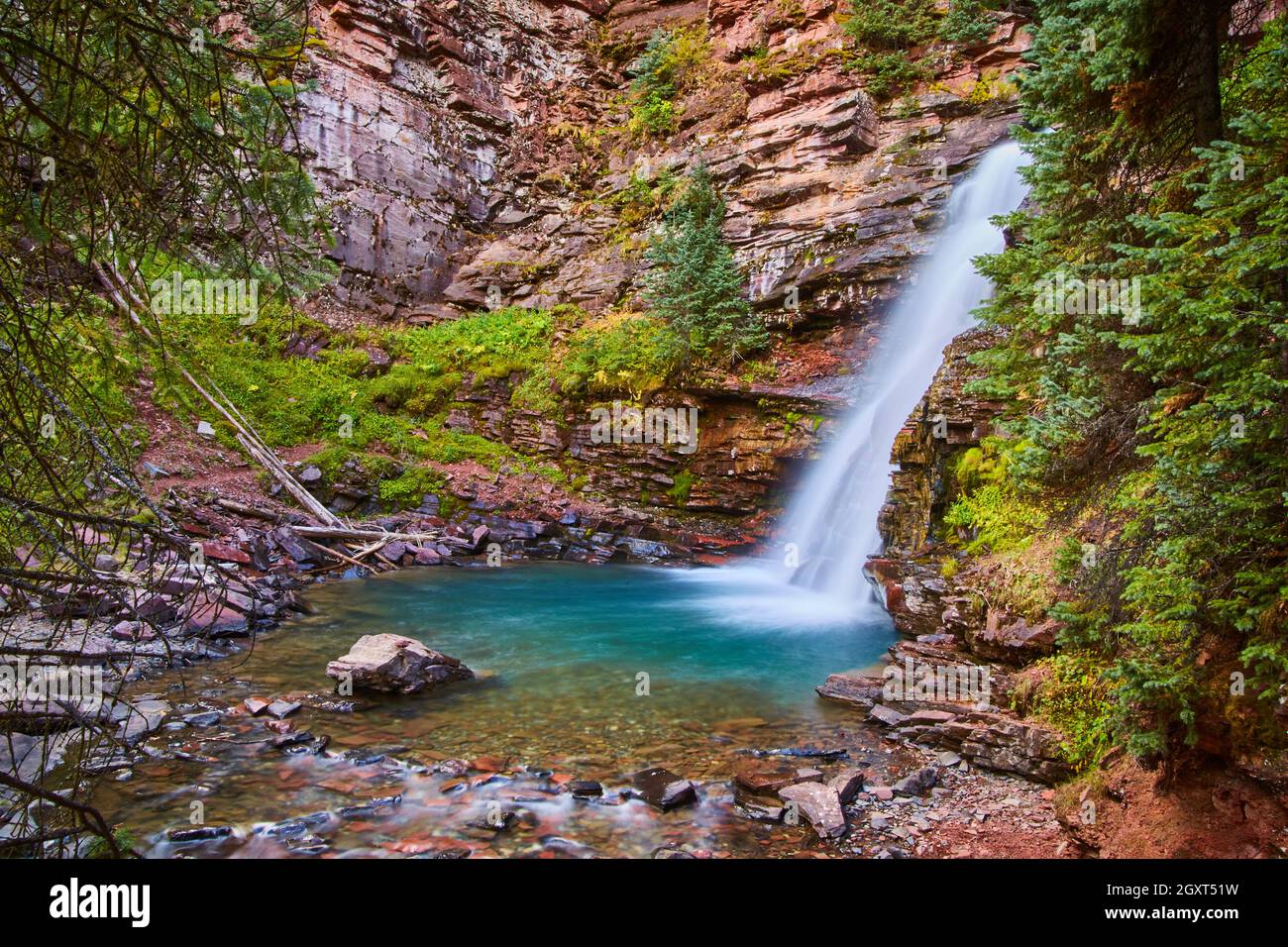 Majestic waterfall tucked into small gorge of mountains Stock Photo - Alamy