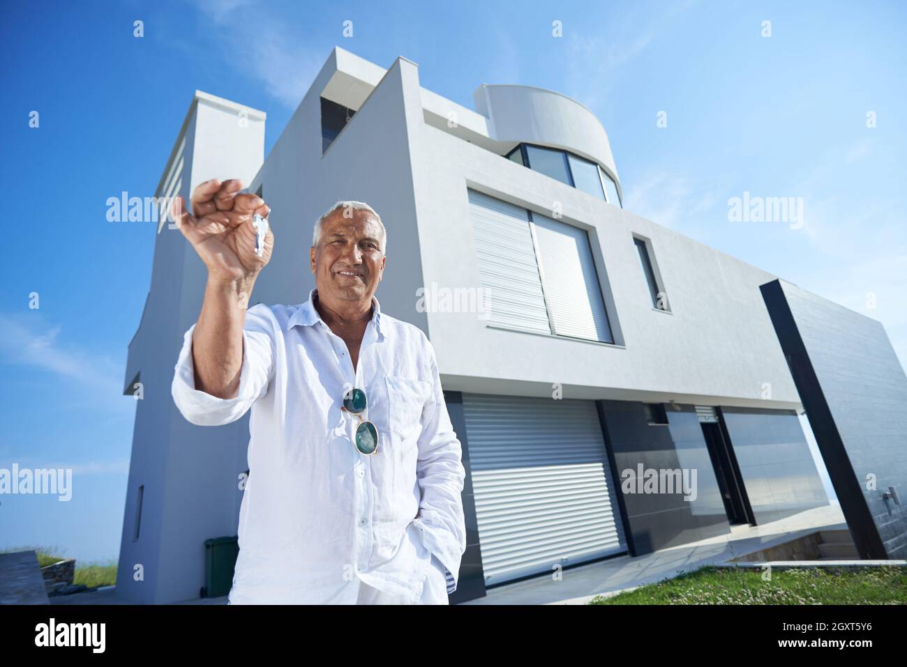 senior man in front of luxury modern home villa Stock Photo - Alamy