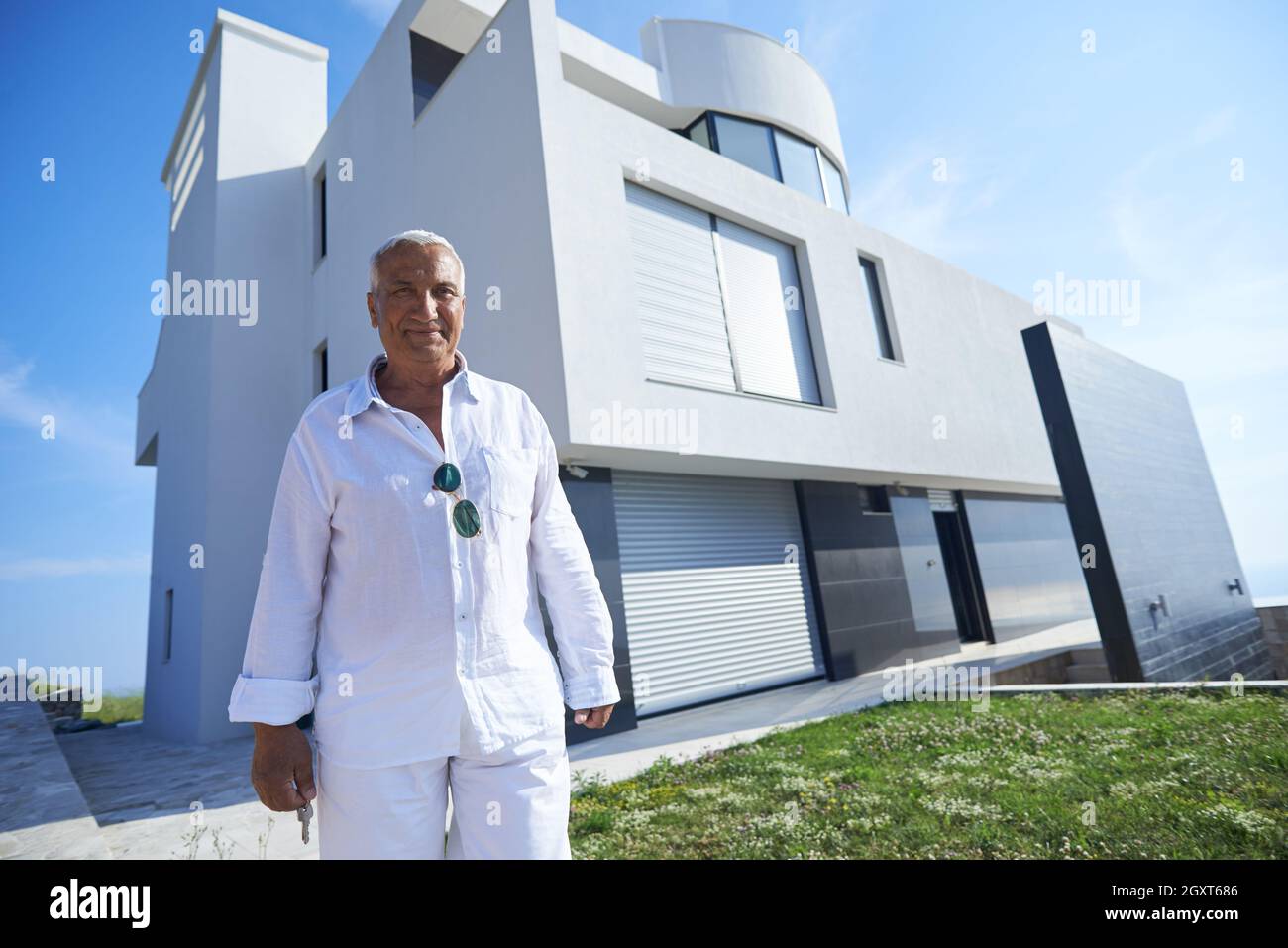 senior man in front of luxury modern home villa Stock Photo - Alamy