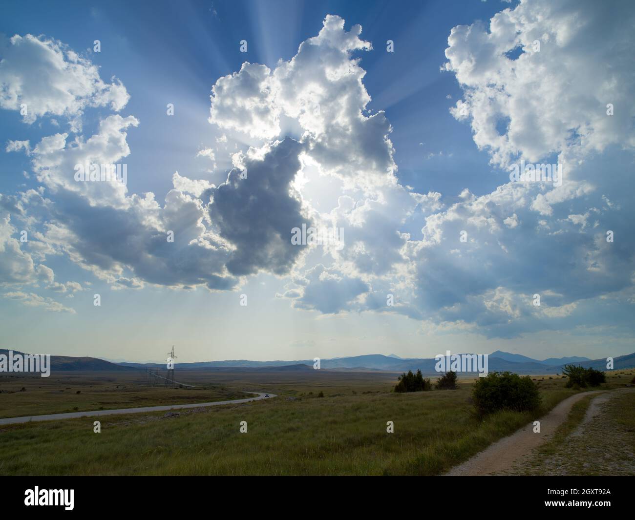 Evening summer landscape with green grass, road and clouds Stock Photo ...