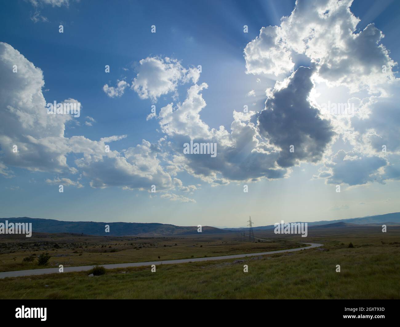 Evening summer landscape with green grass, road and clouds Stock Photo ...