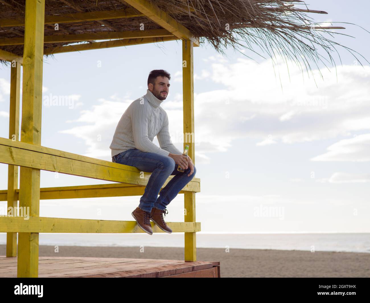 Man Drinking Beer on beach during autumn time Stock Photo - Alamy