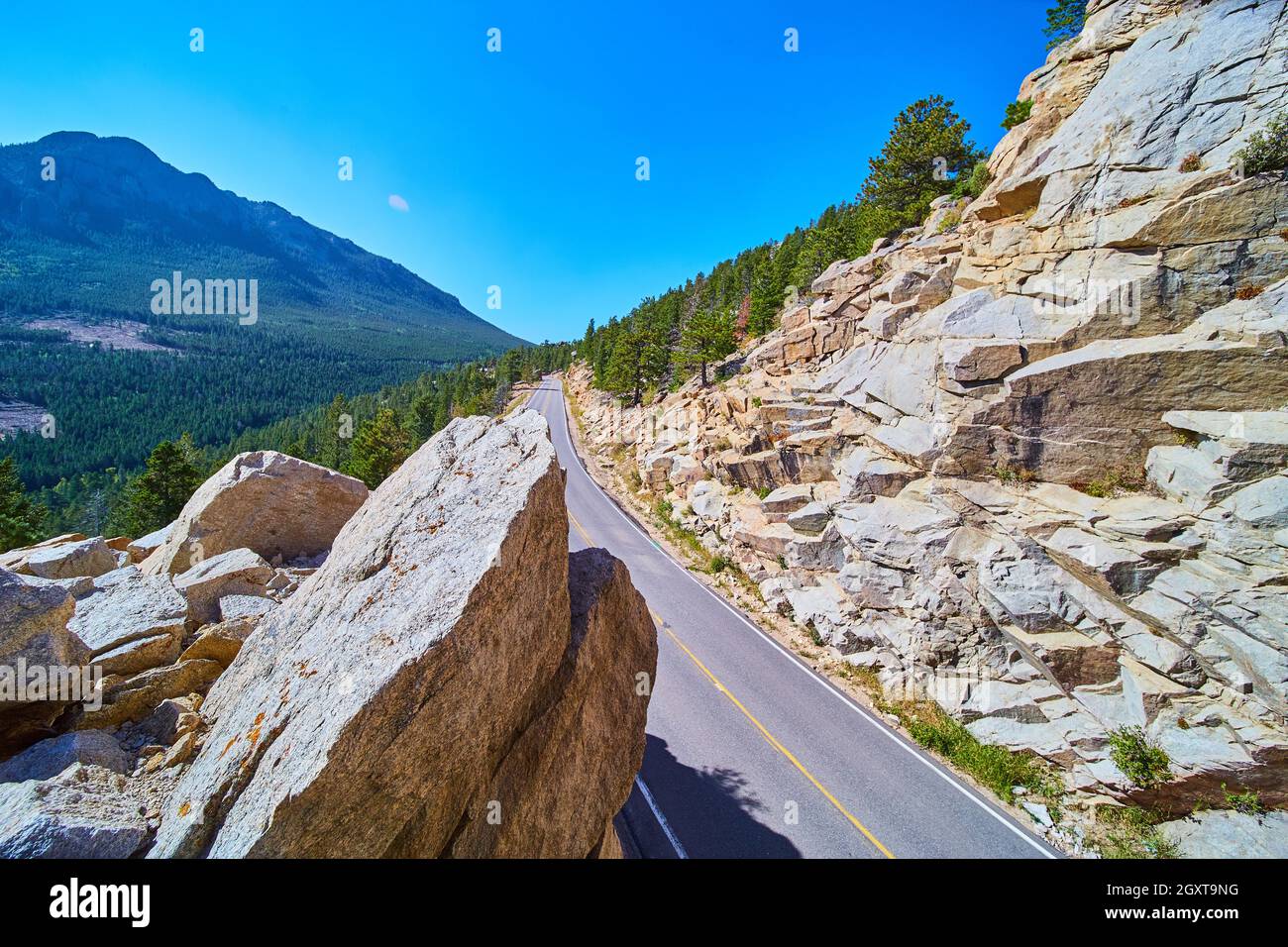 Road tourism travel landscape cutting through mountain with boulders ...