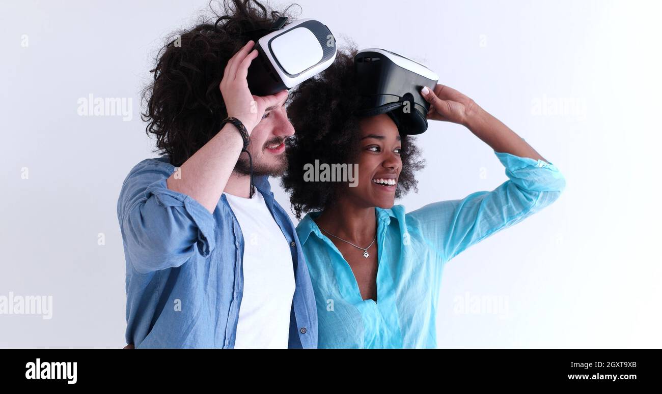 Happy multiethnic couple getting experience using VR headset glasses of ...