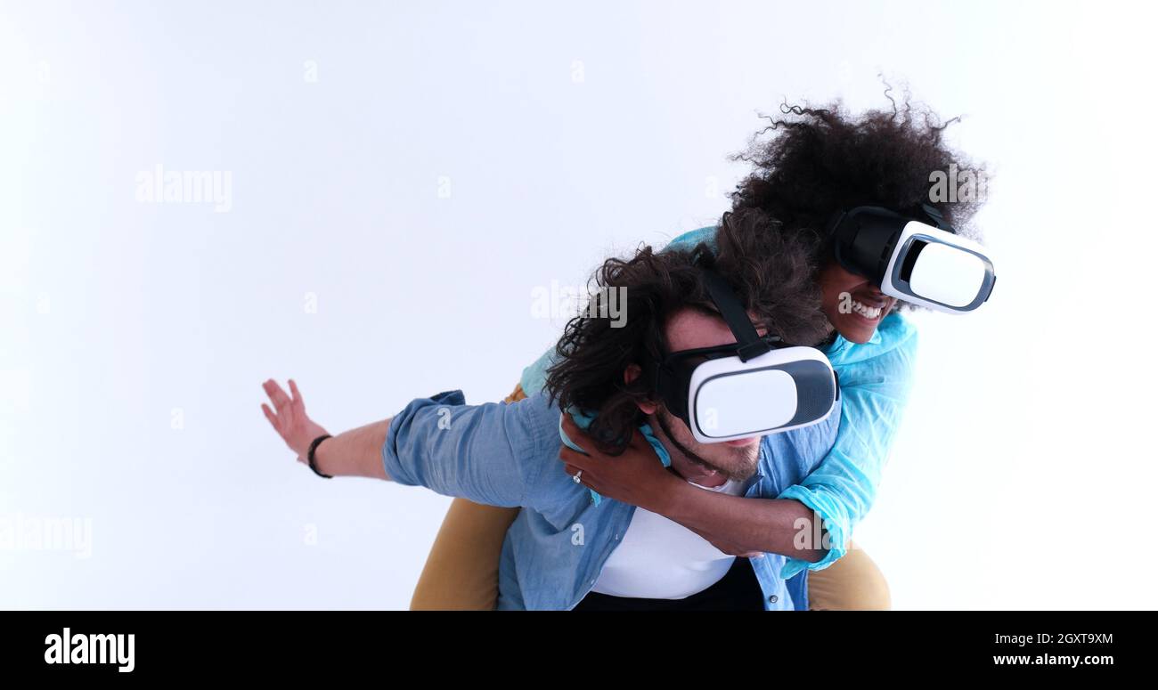 Happy multiethnic couple getting experience using VR headset glasses of ...
