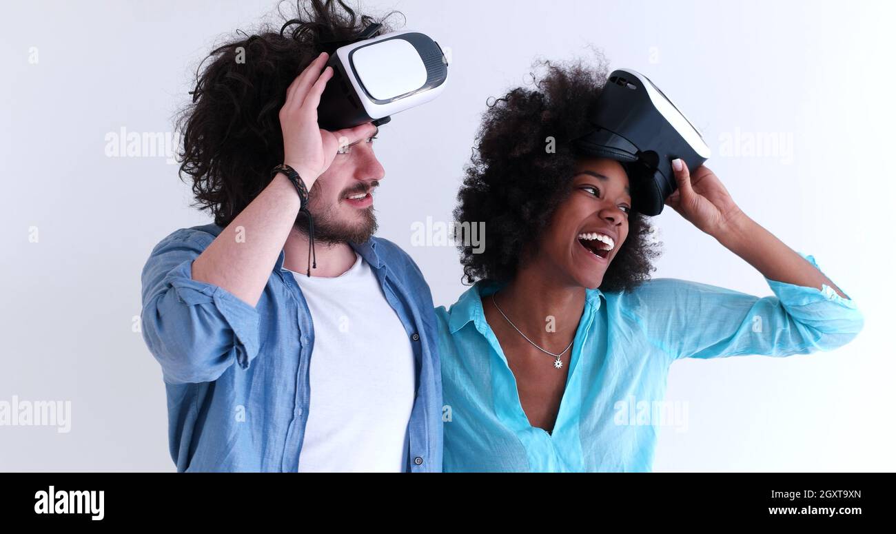 Happy multiethnic couple getting experience using VR headset glasses of ...