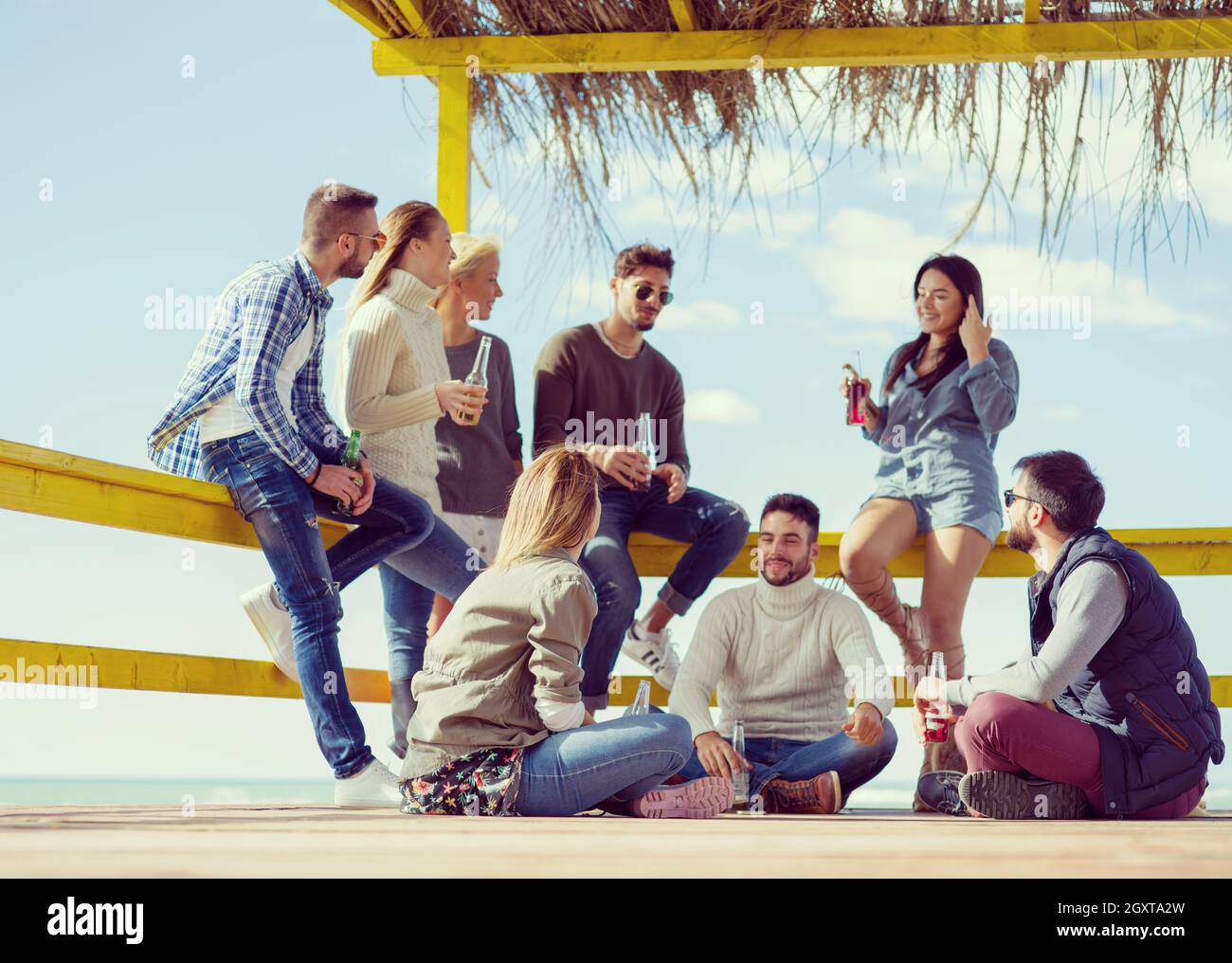 Happy Group Of Friends Hanging Out At Beach House having fun and ...