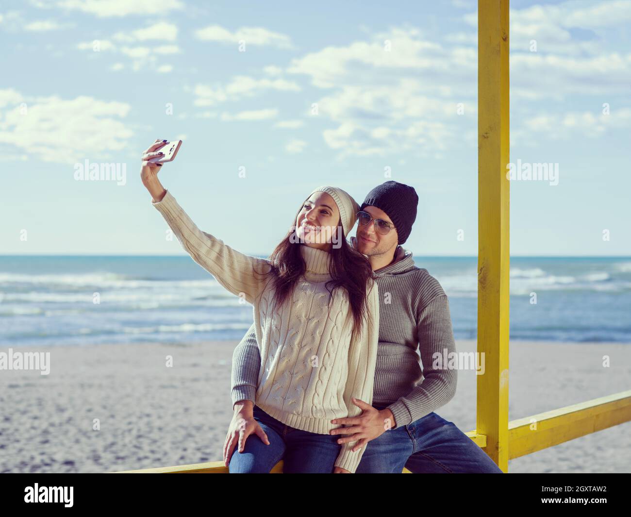 Very Happy Couple In Love Taking Selfie On The Beach In Autmun Day