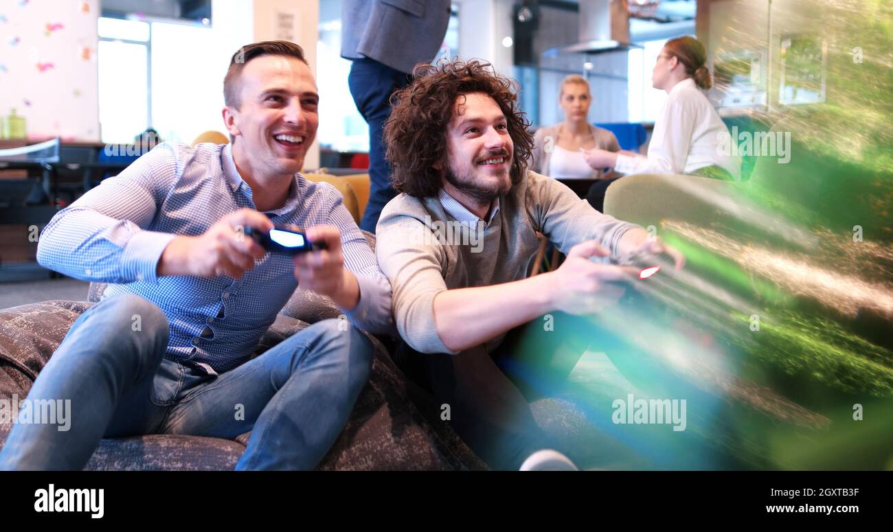 Work hard play hard. Office Workers Playing computer games Stock Photo ...