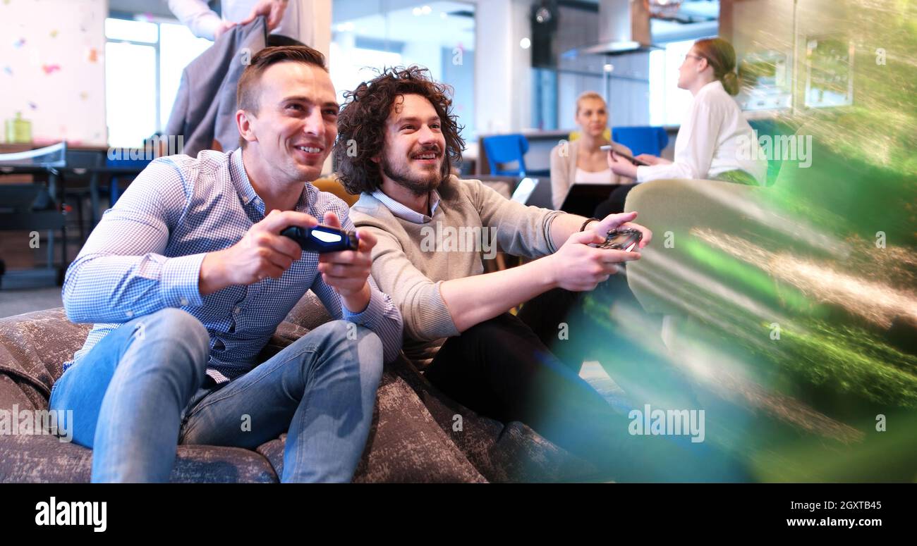 Work hard play hard. Office Workers Playing computer games Stock Photo ...