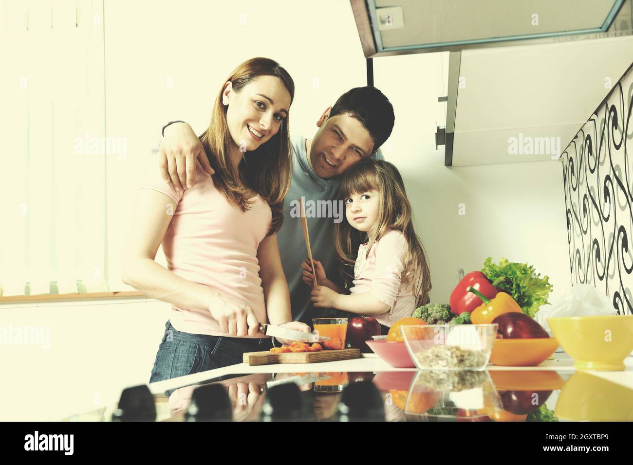 happy young family have lunch time with fresh fruits and vegetable food ...