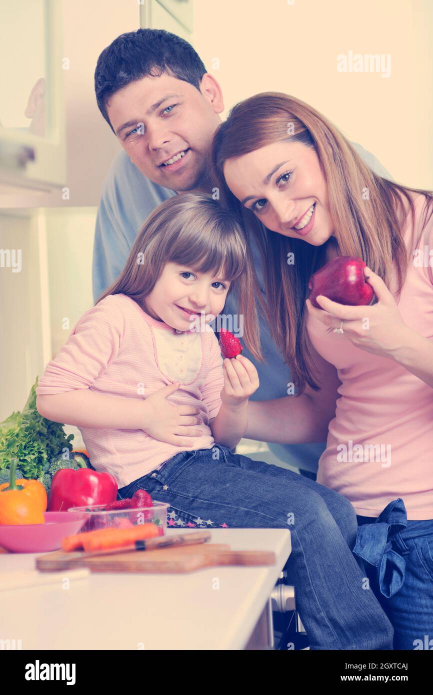 happy young family have lunch time with fresh fruits and vegetable food ...