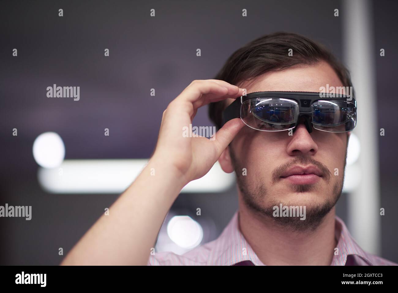 young man using virtual reality gadget computer technology glasses ...