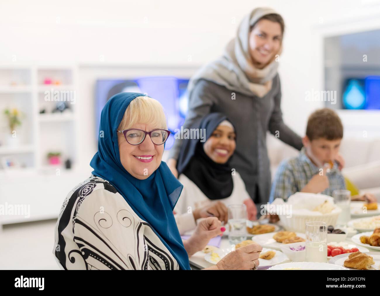 modern multiethnic muslim family enjoying eating iftar dinner together ...