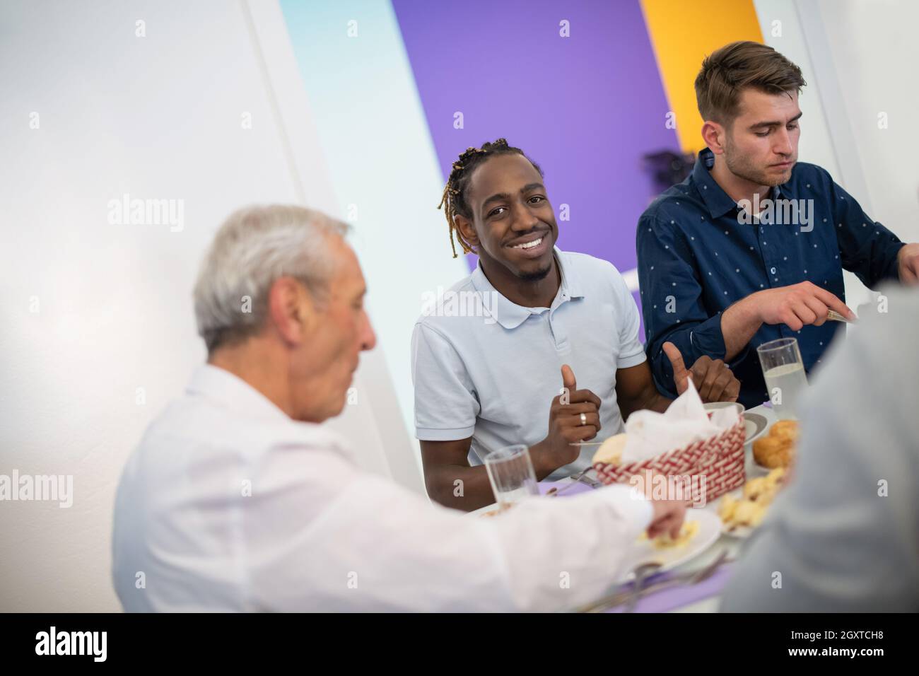 african american man enjoying iftar dinner together with modern ...