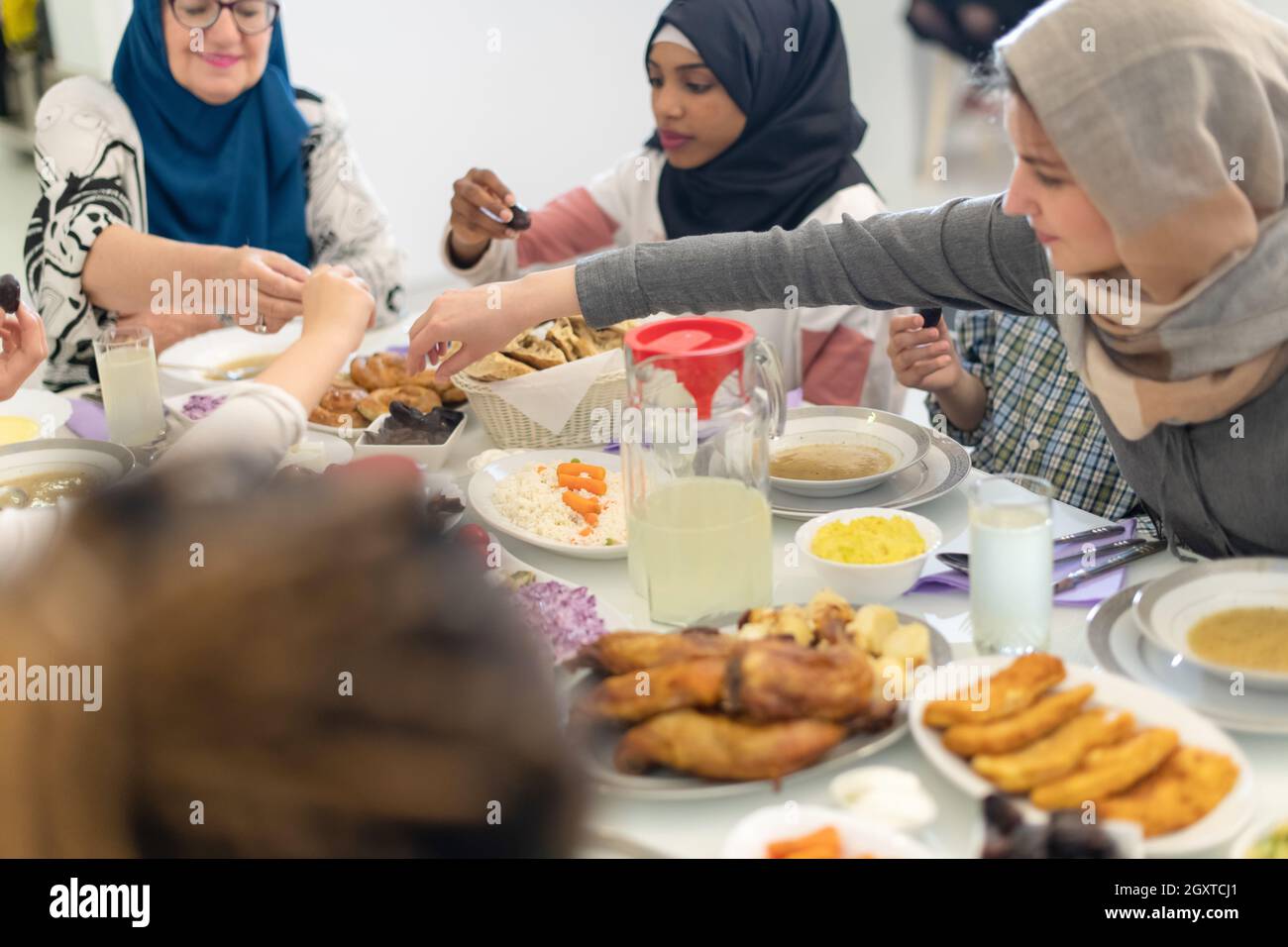 modern multiethnic muslim family enjoying eating iftar dinner together ...
