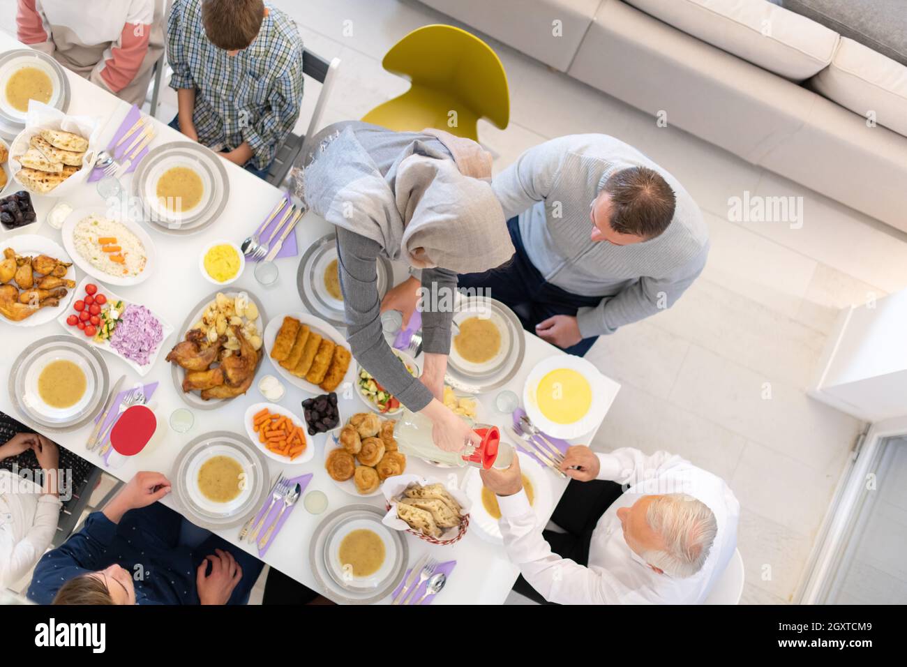 top view of modern multiethnic muslim family enjoying eating iftar ...