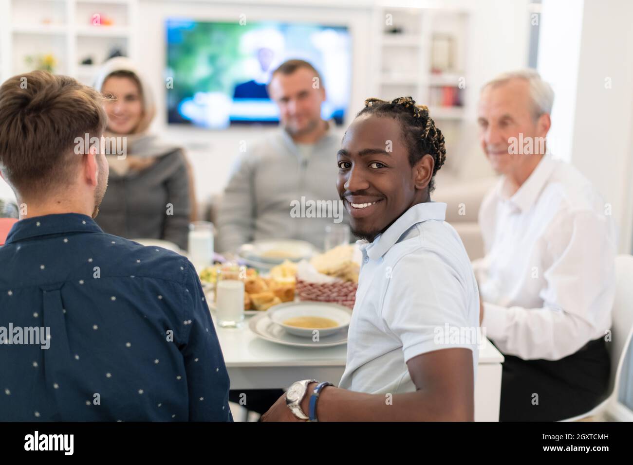 african american man enjoying iftar dinner together with modern ...
