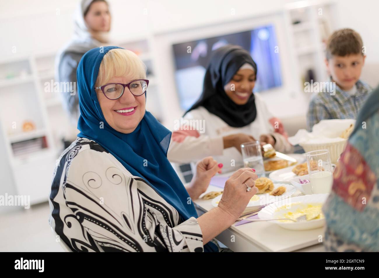modern multiethnic muslim family enjoying eating iftar dinner together ...