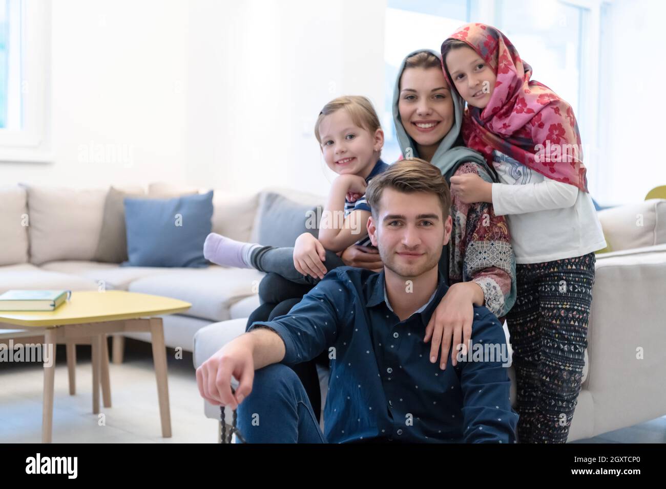 portrait of young happy modern muslim family before iftar dinner during ...