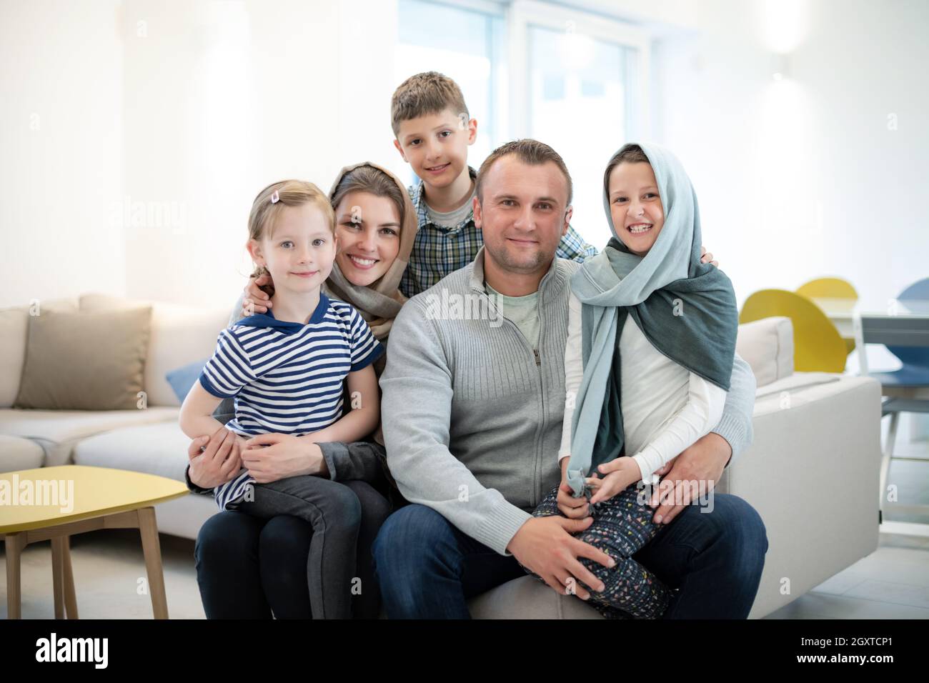portrait of young happy modern muslim family before iftar dinner during ...