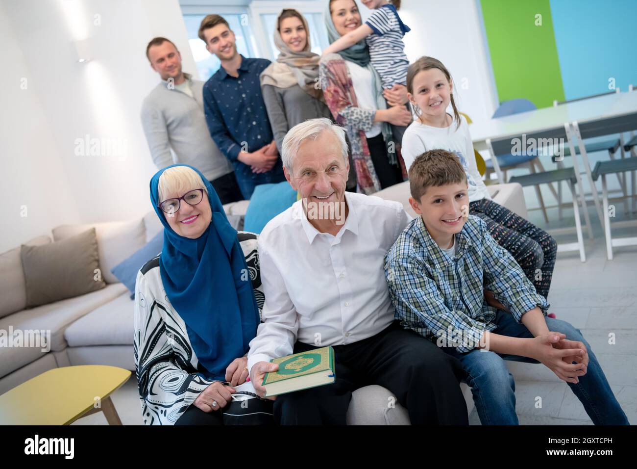 several generations portrait of happy modern muslim family before iftar ...