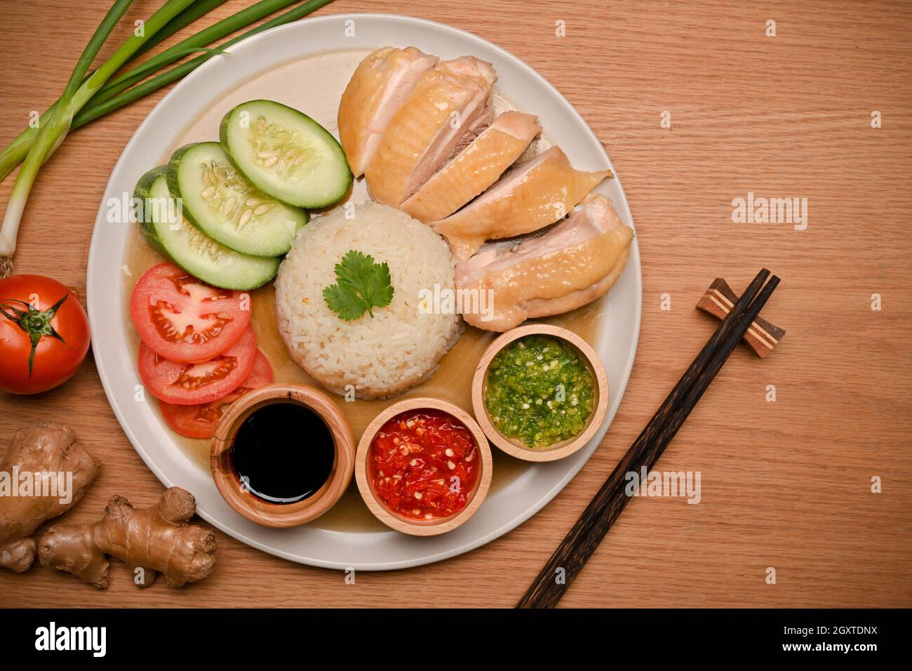Delicious Hainanese chicken rice is served with three different sauces ...