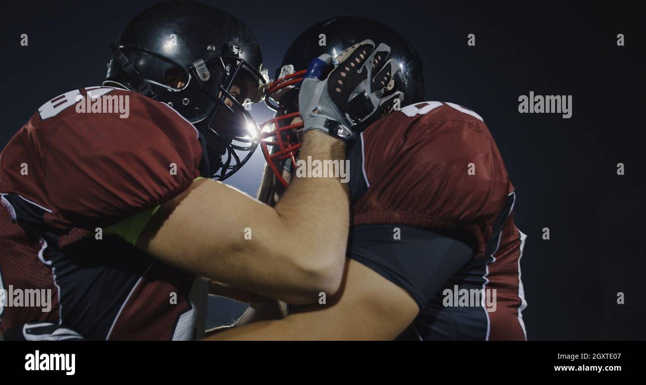 American Football Players having fun and knocking each other with ...