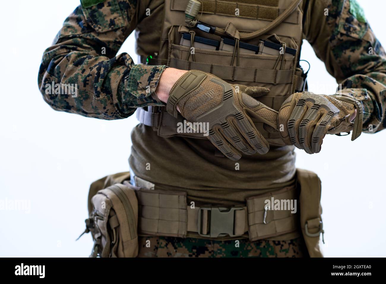 closeup of modern warfare soldier hands putting protective battle ...