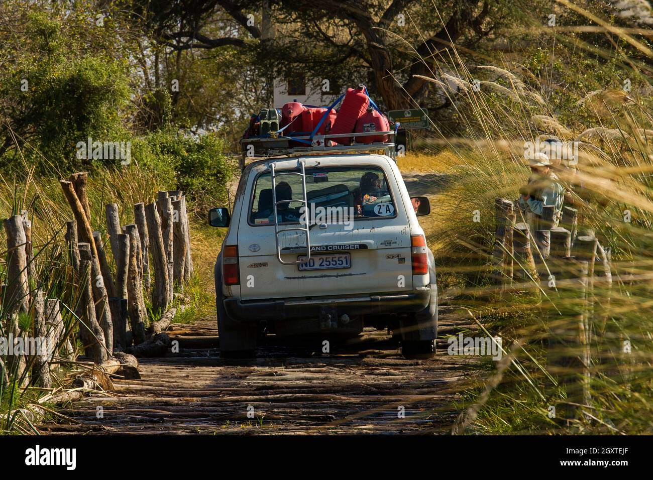 Safari car crossing the popular Third Bridge, Moremi Game Reserve ...