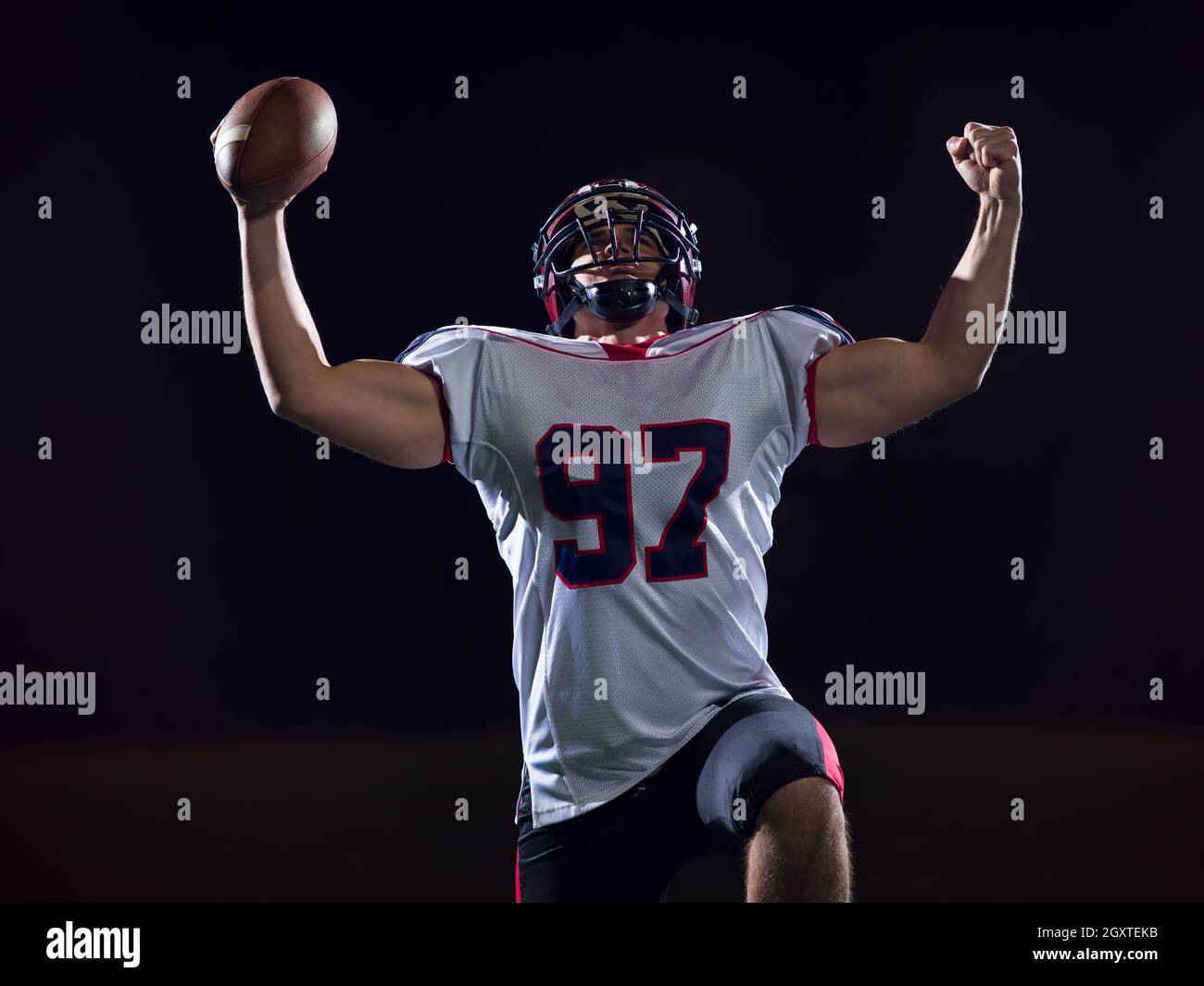 american football player celebrating after scoring a touchdown on field ...