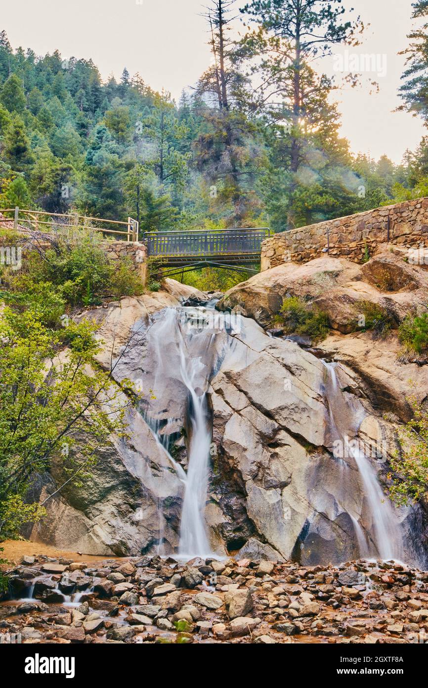 Walking bridge over waterfall in mountains Stock Photo - Alamy