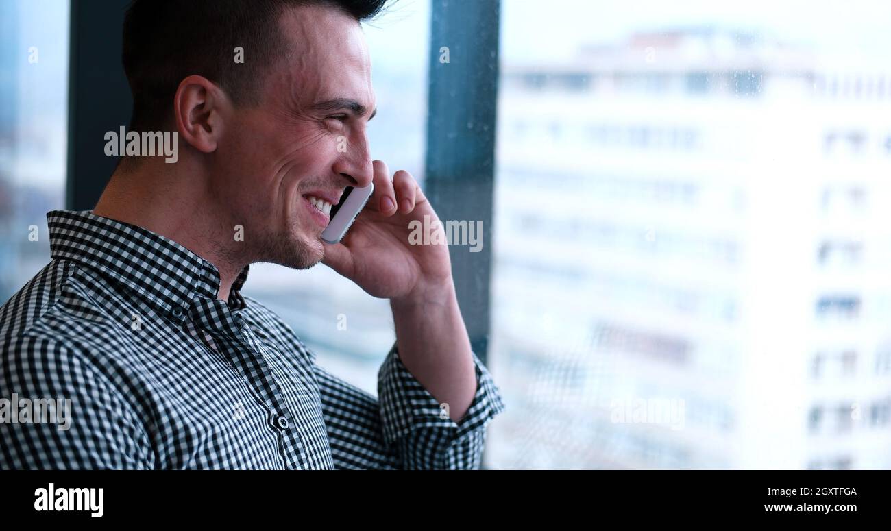 laughing man talking on the phone in office interior Stock Photo - Alamy