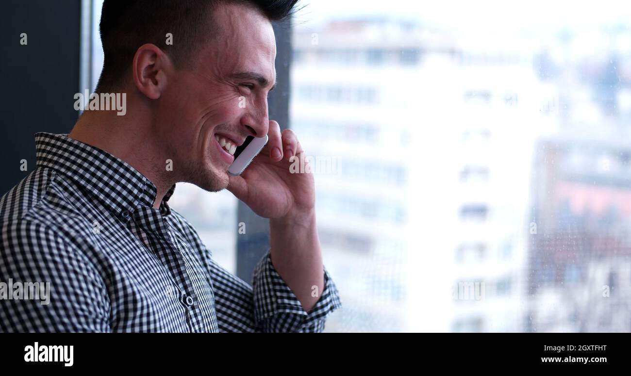 laughing man talking on the phone in office interior Stock Photo - Alamy