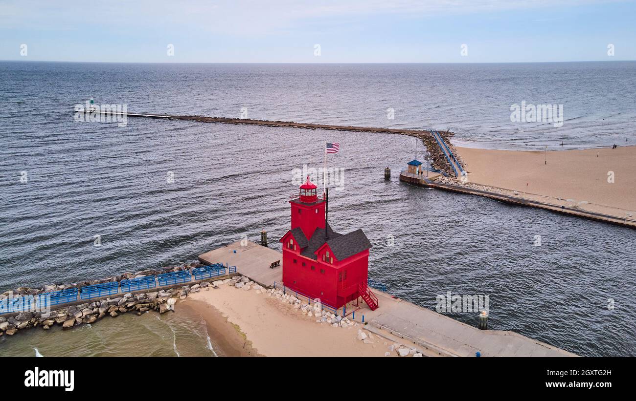 View of red lighthouse overlooking great lake Stock Photo - Alamy